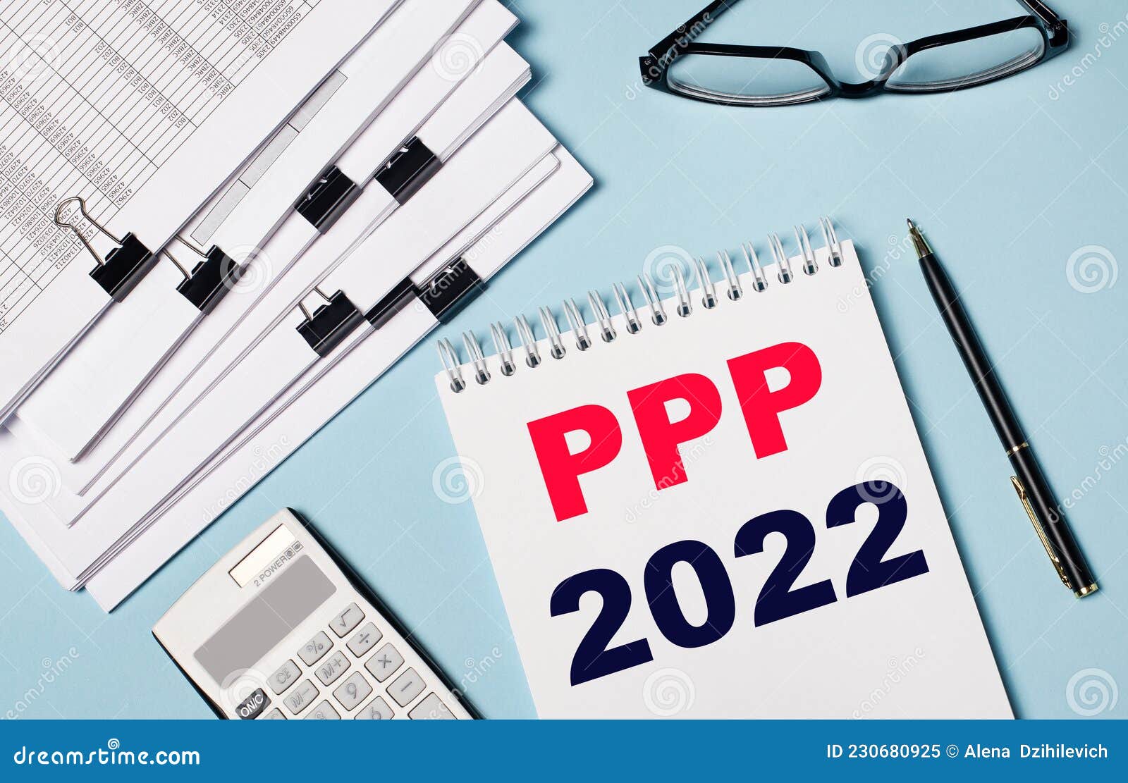On a Light Blue Background There are Documents, Glasses, a Calculator ...