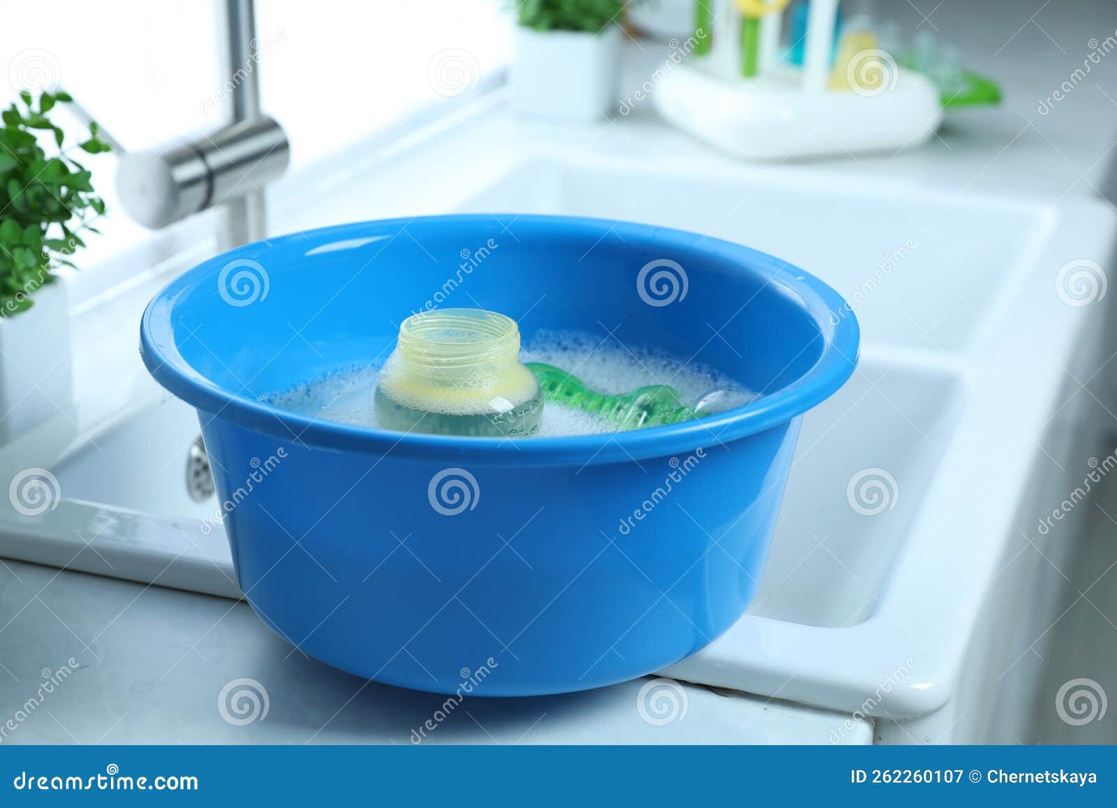 Light Blue Basin with Baby Bottles on White Countertop in Kitchen Stock ...