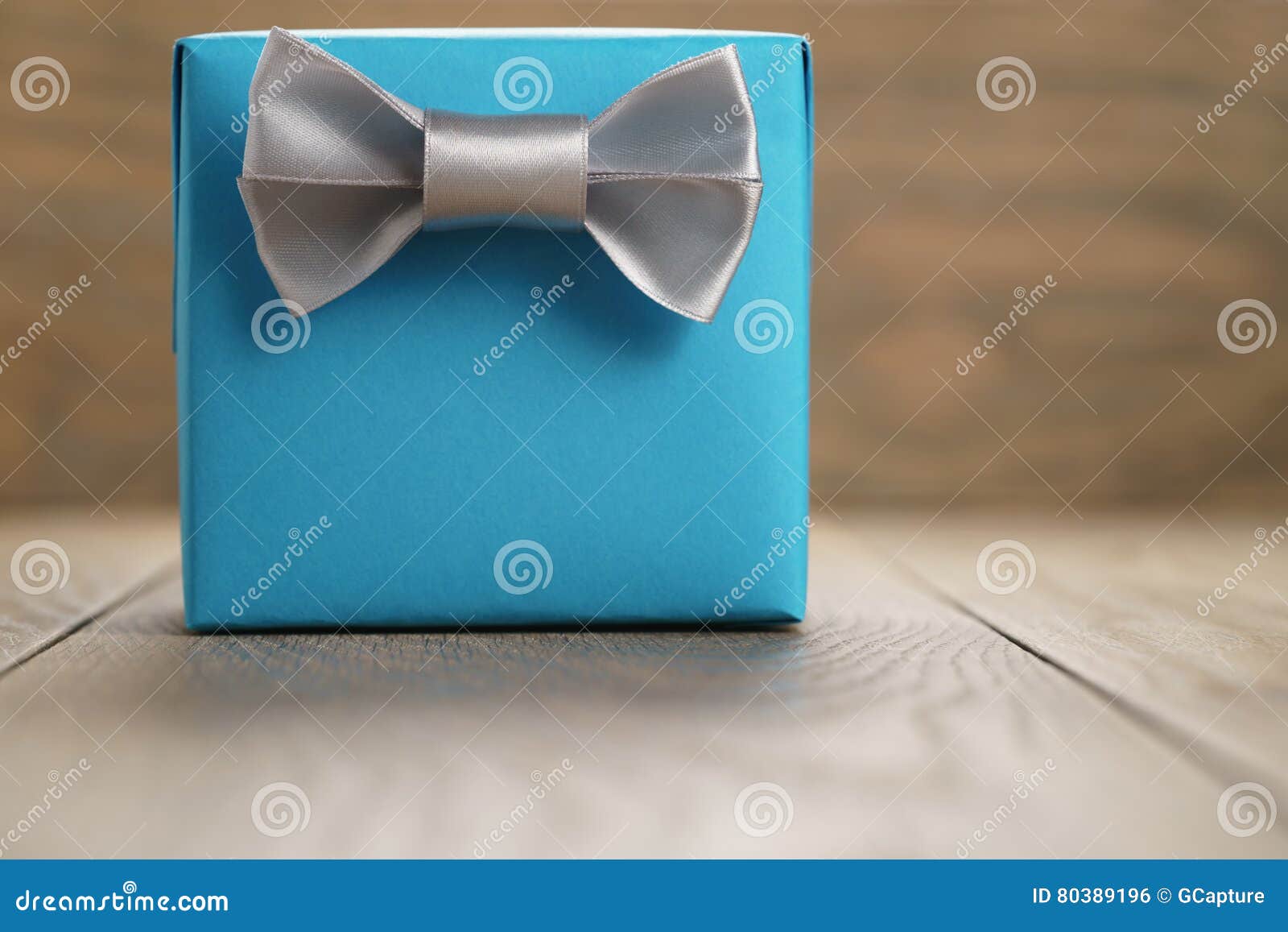 Light Blue Gift Box with Minimalistic Silver Ribbon Bow on Wooden Table ...