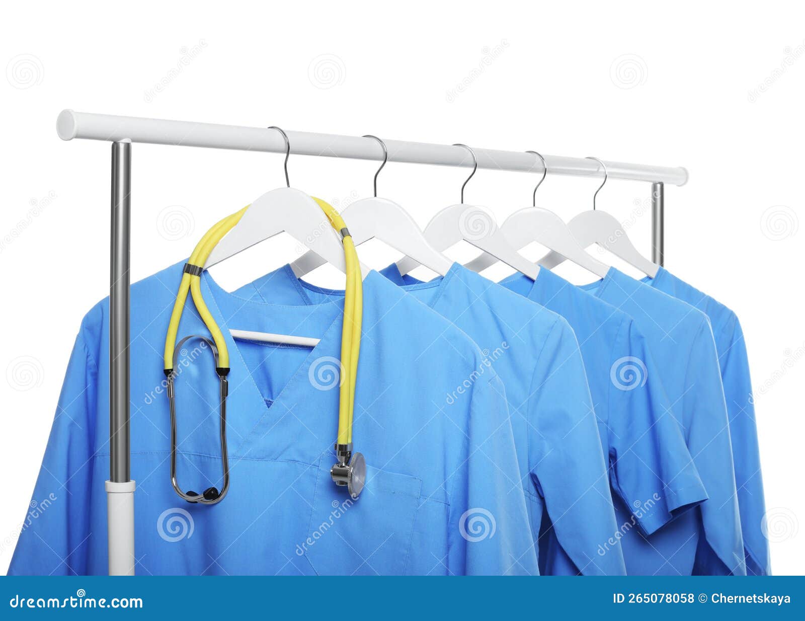 Light Blue Medical Uniforms and Stethoscope on Rack Against White ...