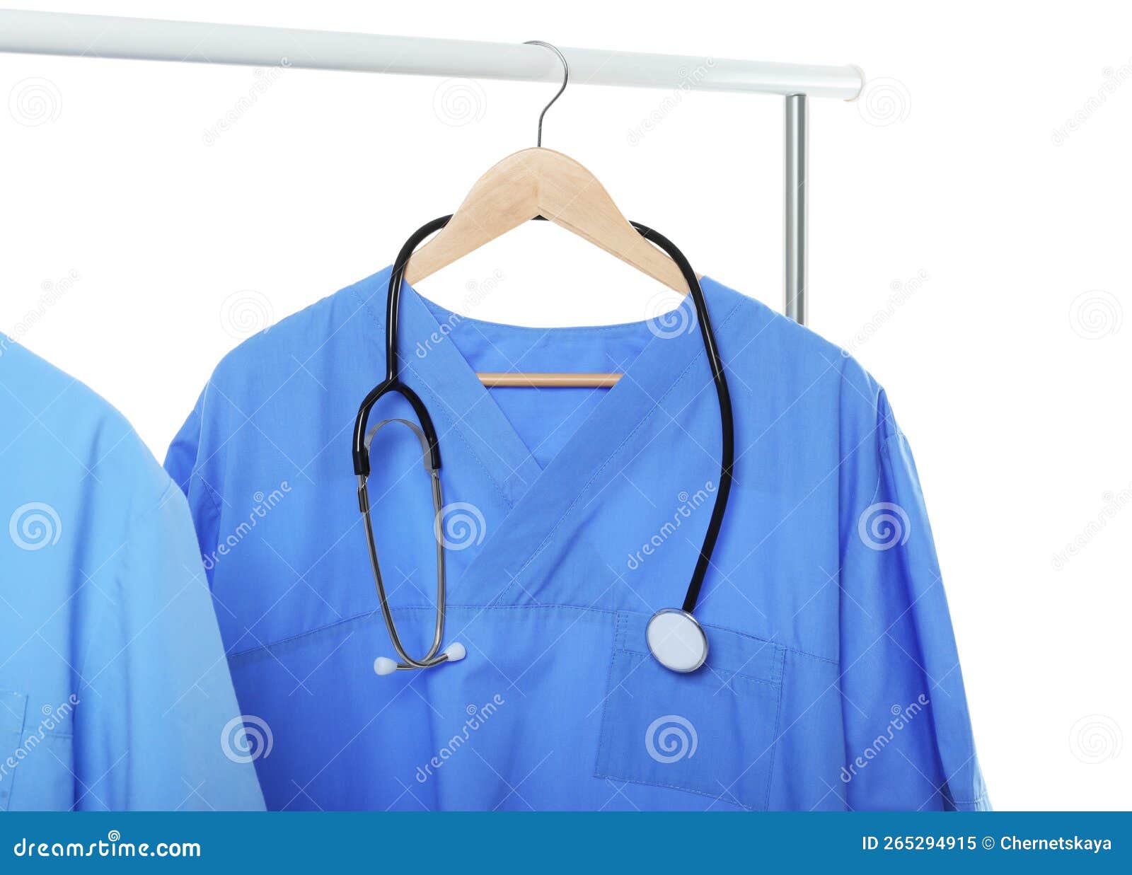 Light Blue Medical Uniforms and Stethoscope on Rack Against White ...