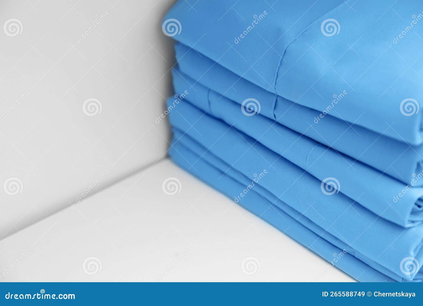Light Blue Medical Uniforms on White Rack, Closeup. Space for Text ...