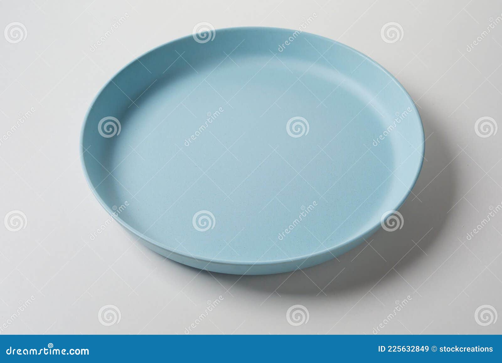Light blue plate on table stock image. Image of high - 225632849