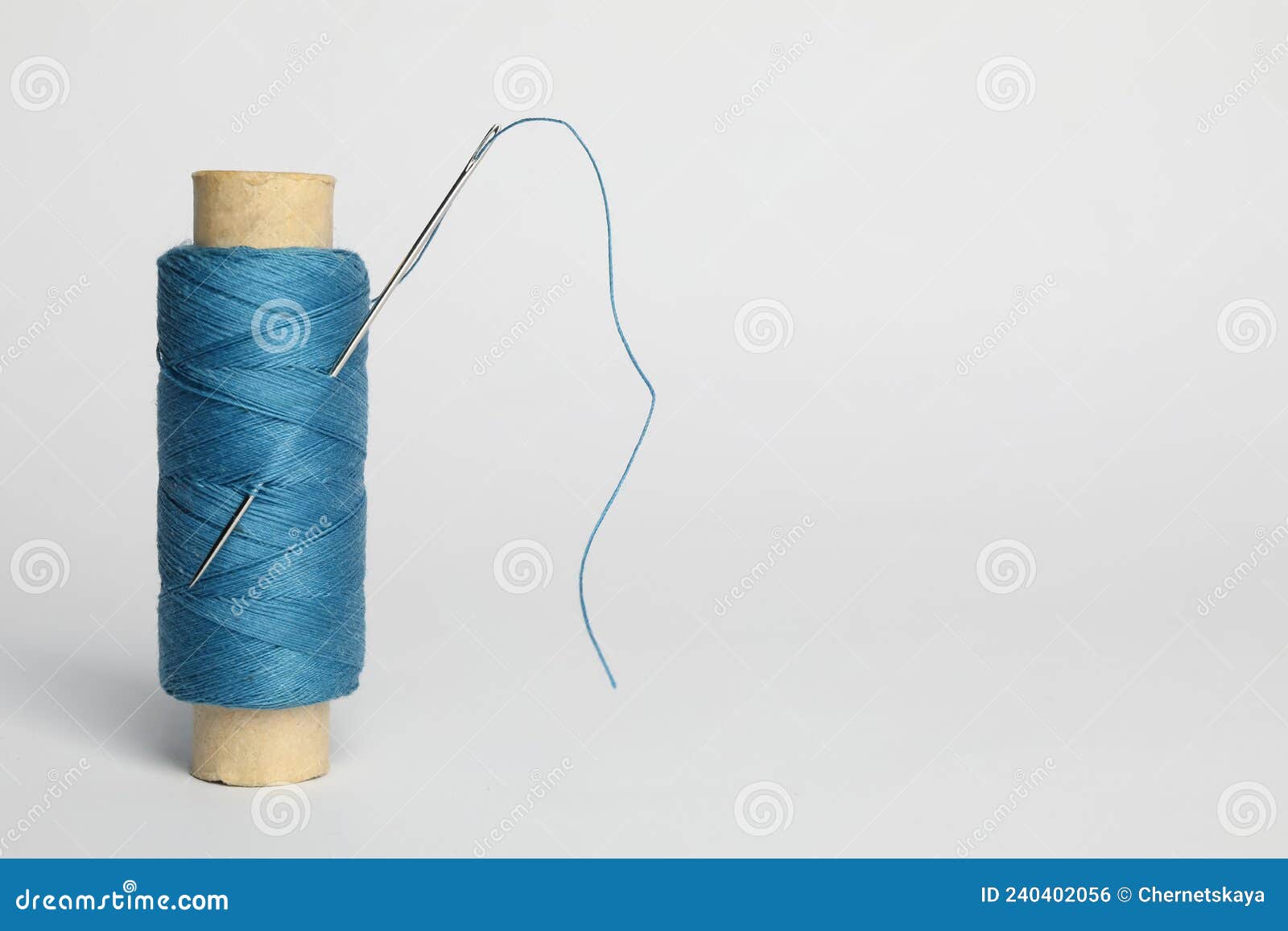 Light Blue Sewing Thread with Needle on White Background Stock Photo ...