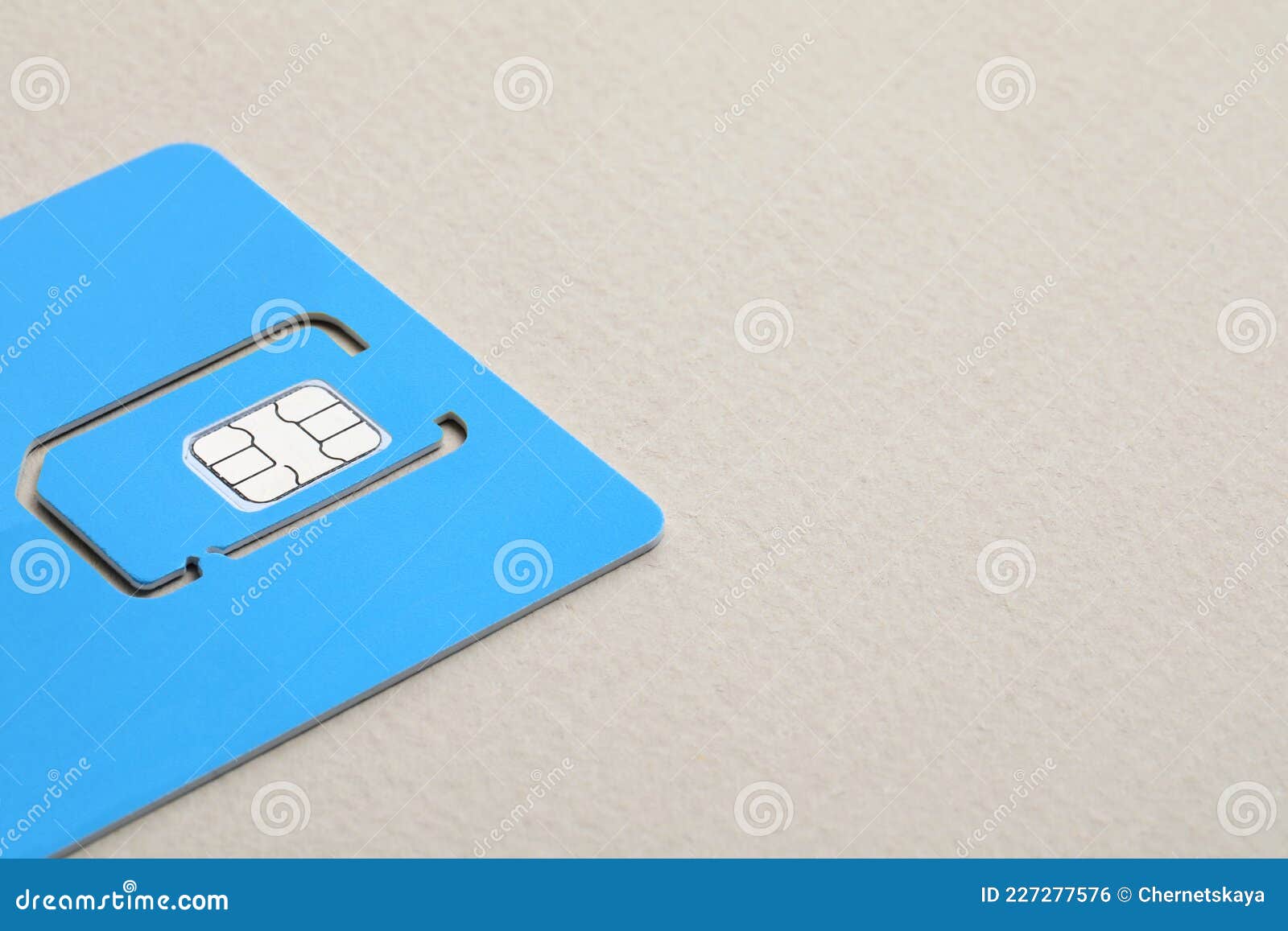 Light Blue SIM Card on Beige Background, Closeup. Space for Text Stock ...