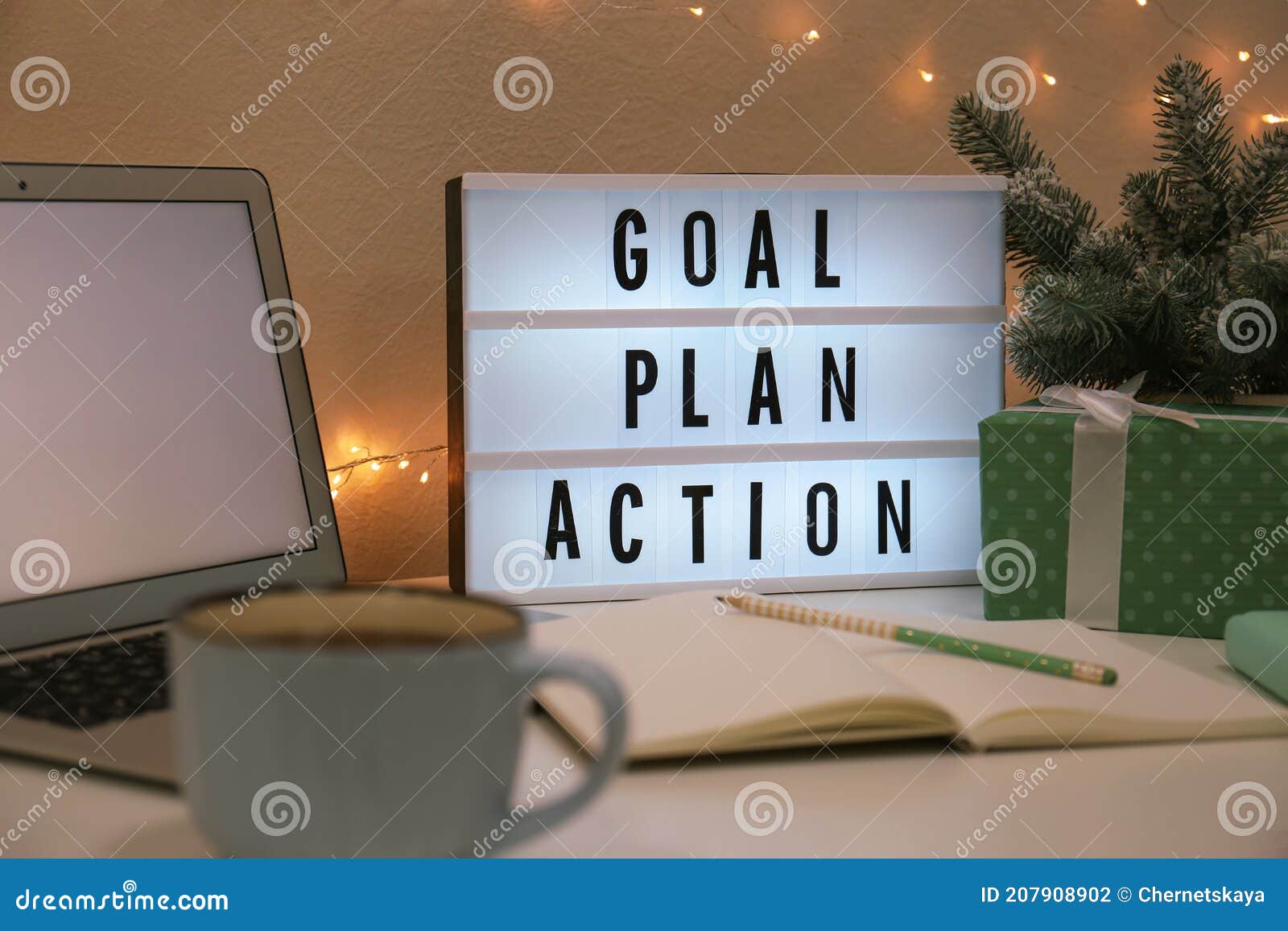 Light Box with Words Goal, Plan, Action Near Laptop and Gift on Table ...