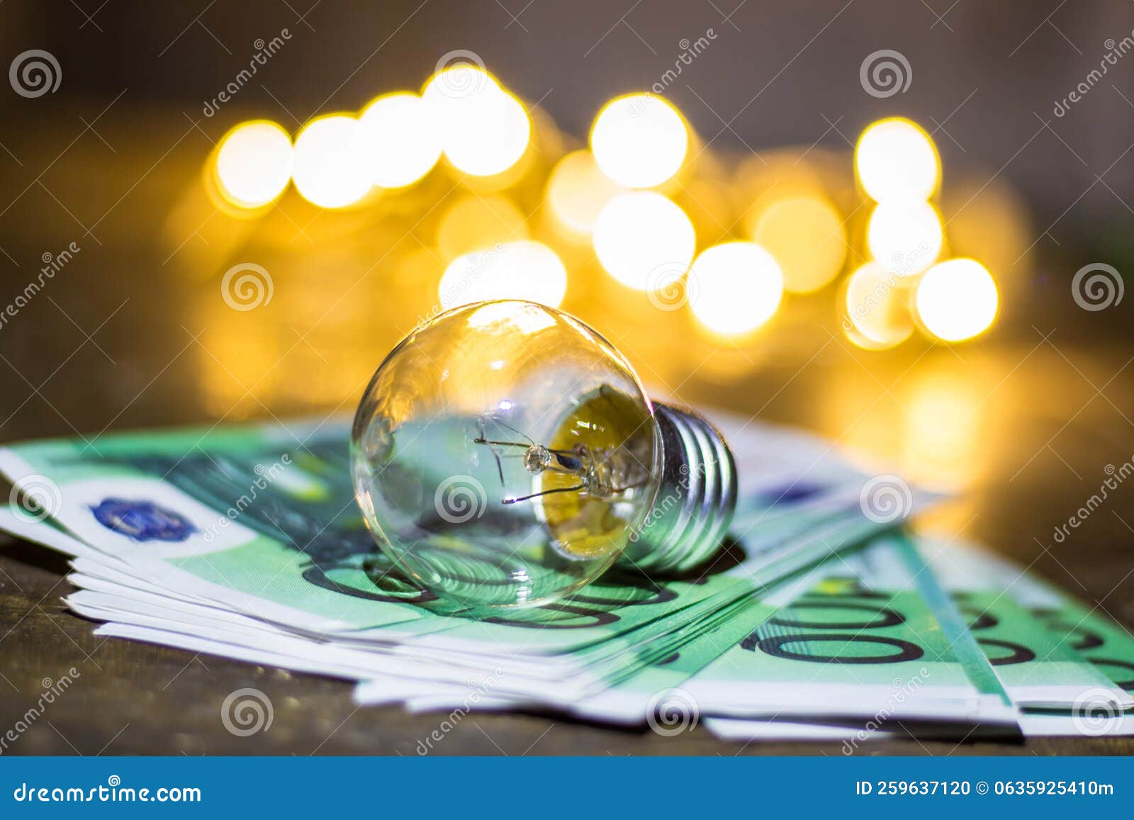 Light bulb on banknotes stock photo. Image of electric - 259637120