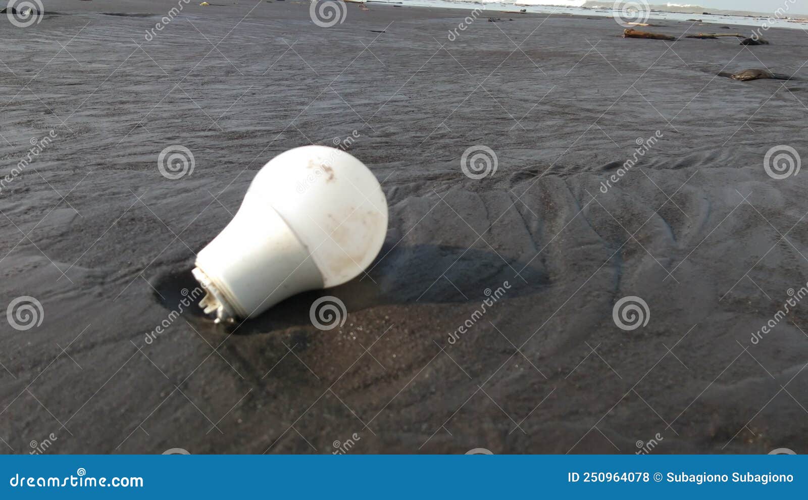 Light bulb and sand stock photo. Image of wing, beach - 250964078