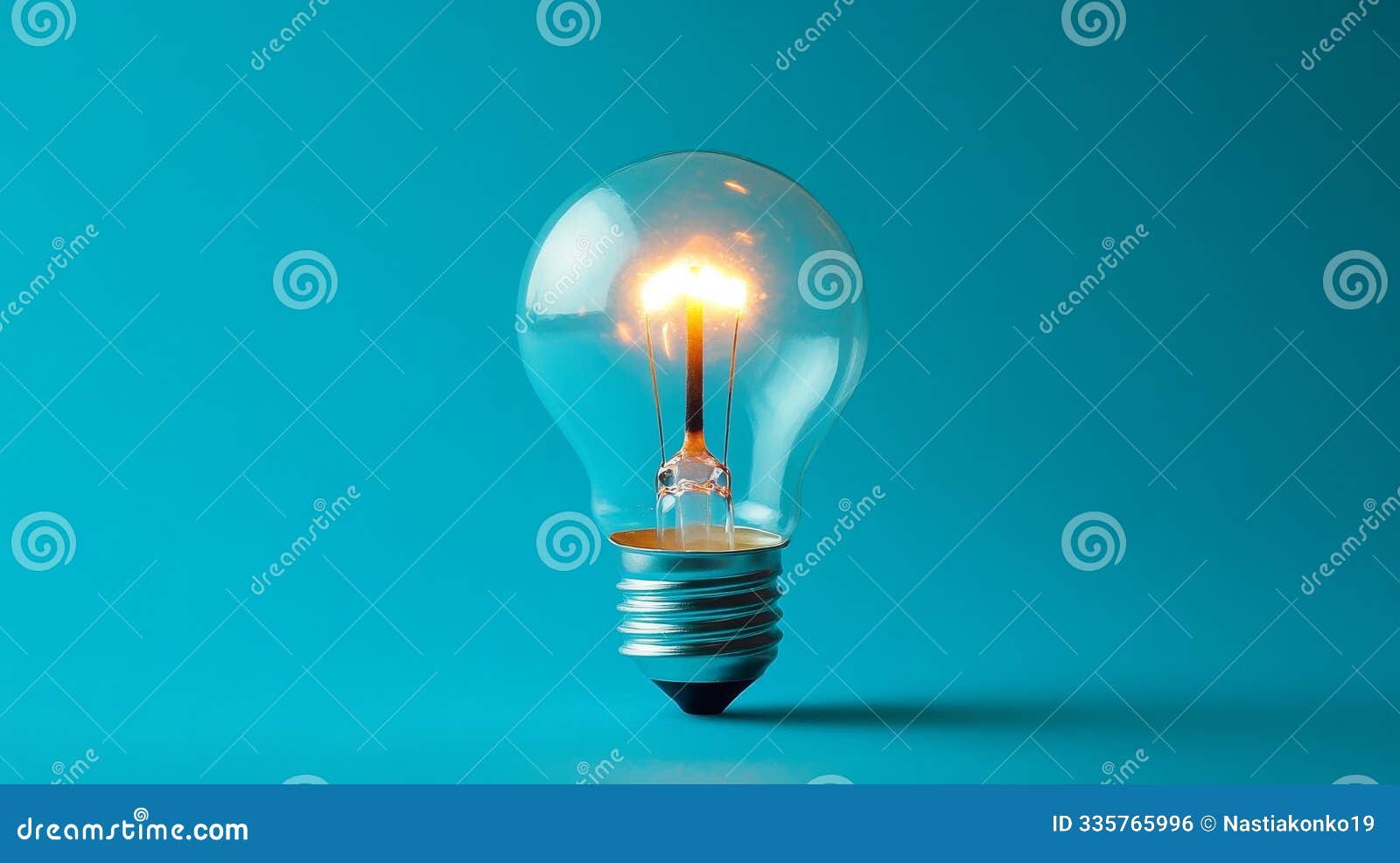Light Bulb on a Blue Background, Illuminated Filament. Innovation and ...
