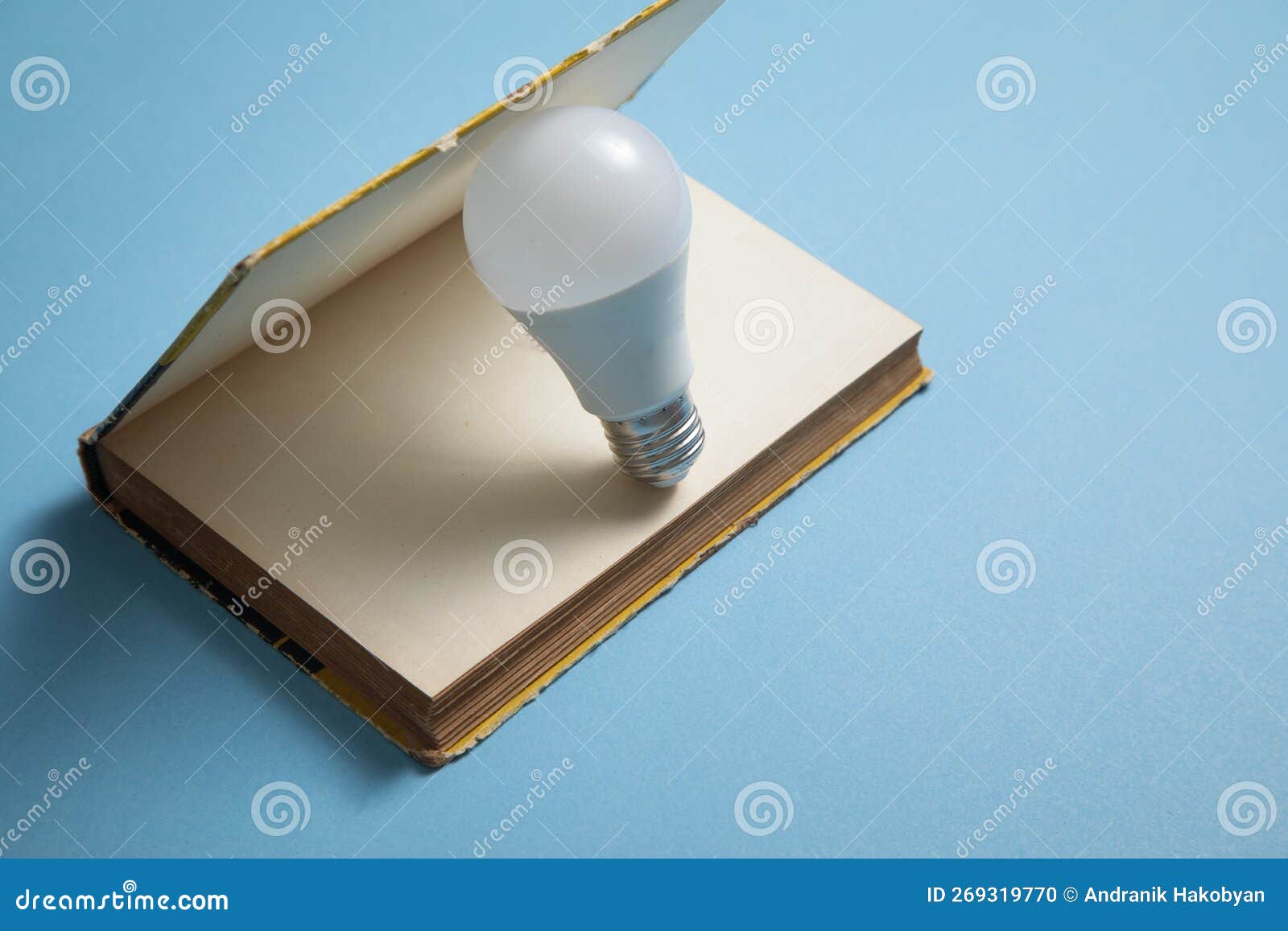 Light Bulb and Book on the Blue Background. Knowledge and Wisdom Stock ...