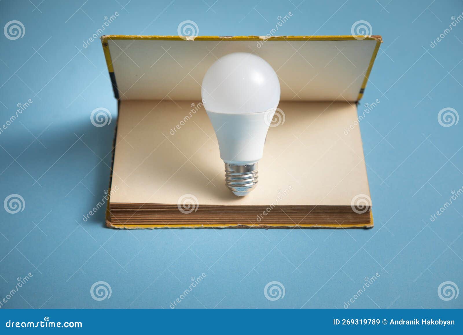 Light Bulb and Book on the Blue Background. Knowledge and Wisdom Stock ...