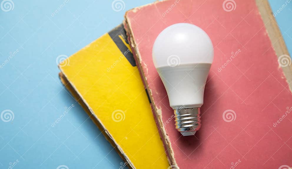 Light Bulb and Book on the Blue Background. Knowledge and Wisdom Stock ...