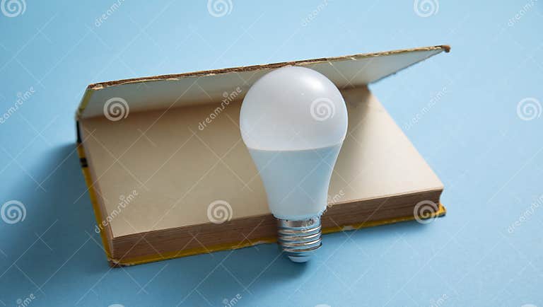 Light Bulb and Book on the Blue Background. Knowledge and Wisdom Stock ...