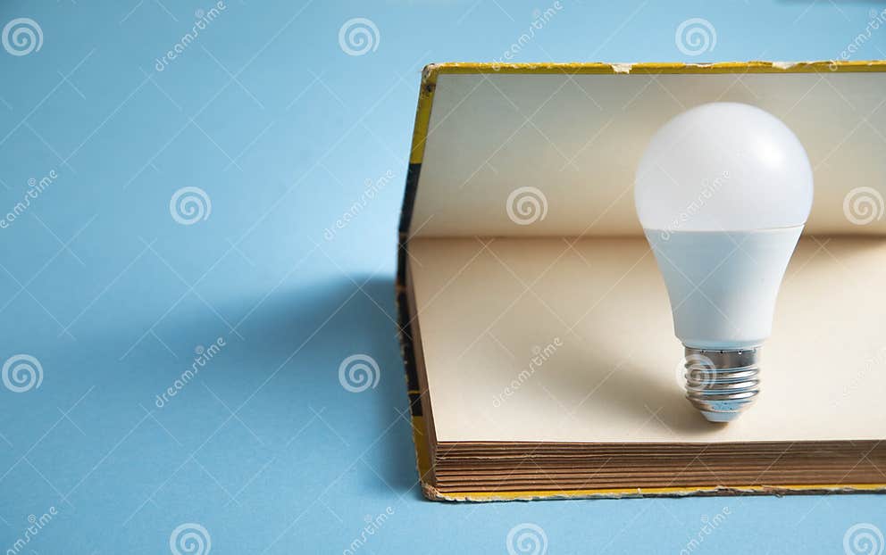 Light Bulb and Book on the Blue Background. Knowledge and Wisdom Stock ...