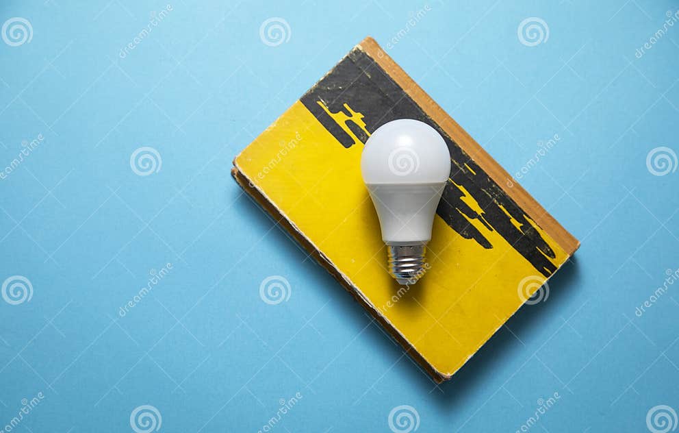 Light Bulb and Book on the Blue Background. Knowledge and Wisdom Stock ...