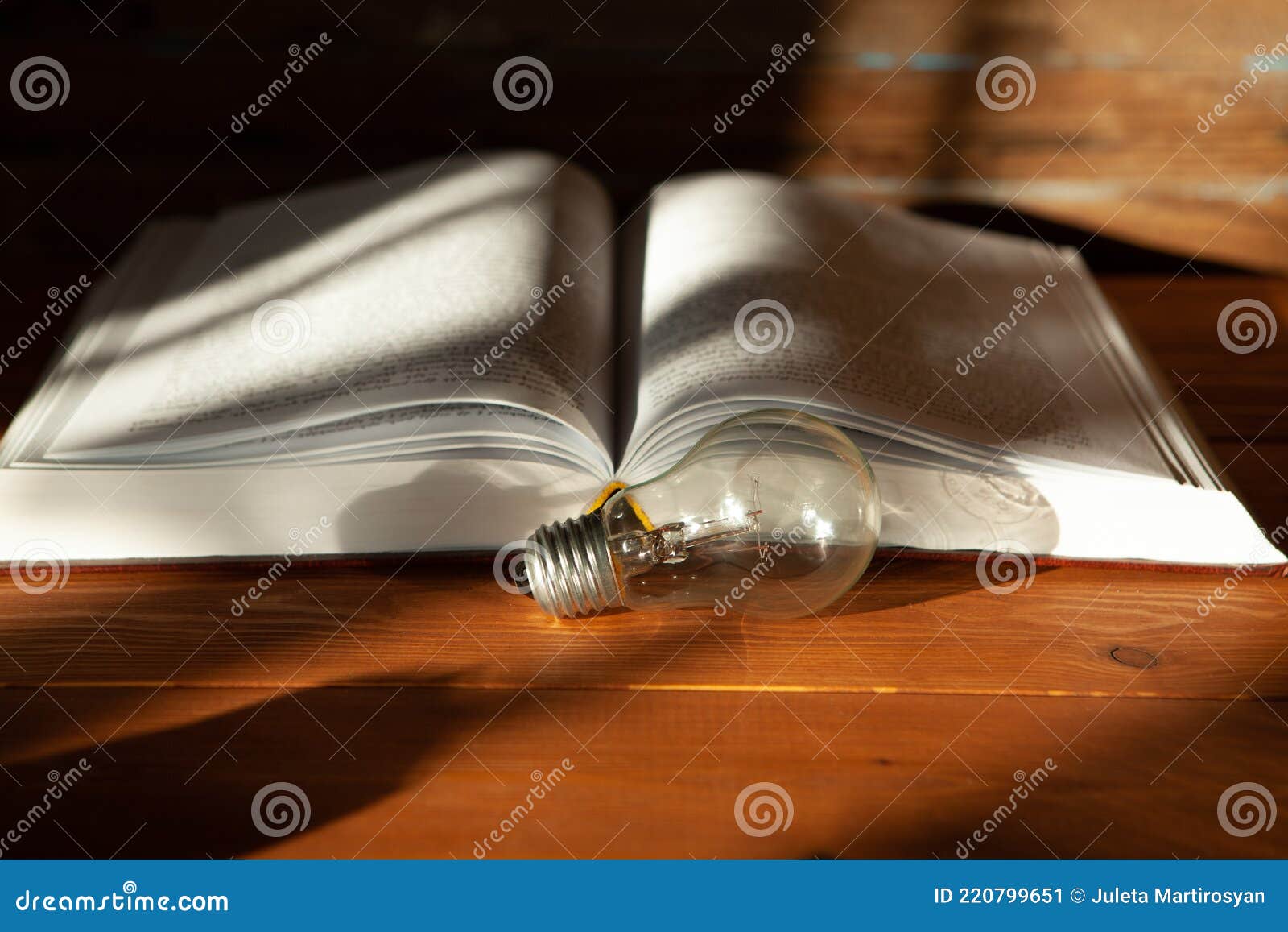 Light Bulb and Book on the Table Stock Image - Image of learn, table ...