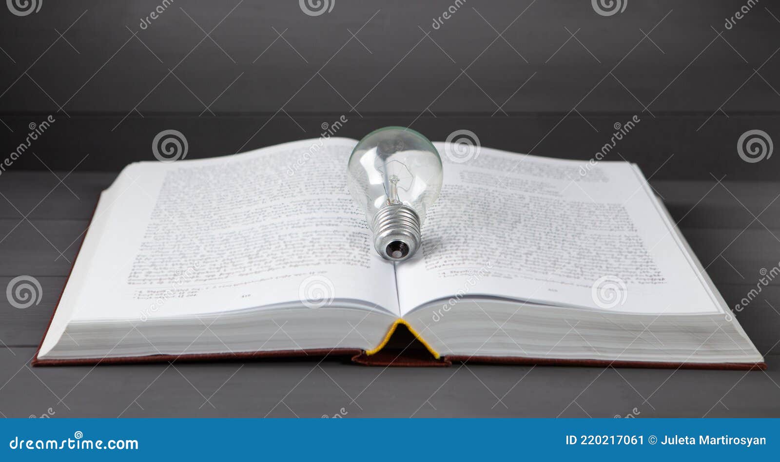 Light Bulb and Book on the Table Stock Image - Image of object, mind ...