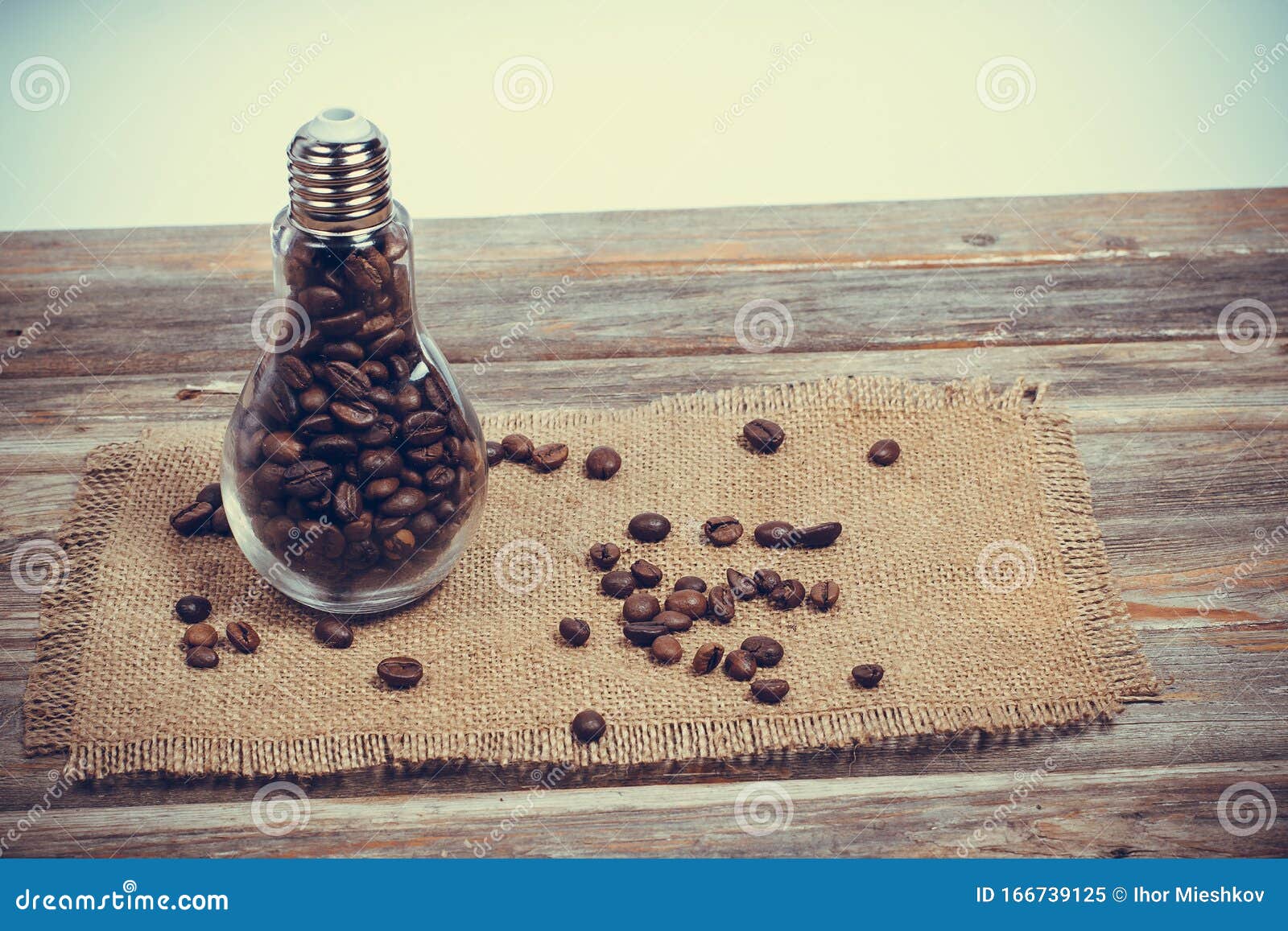 Light Bulb Bottle with Coffee Grains on Vintage Surface Stock Image ...