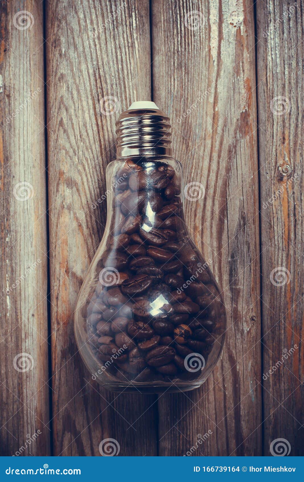 Light Bulb Bottle with Coffee Grains on Vintage Surface Stock Photo ...