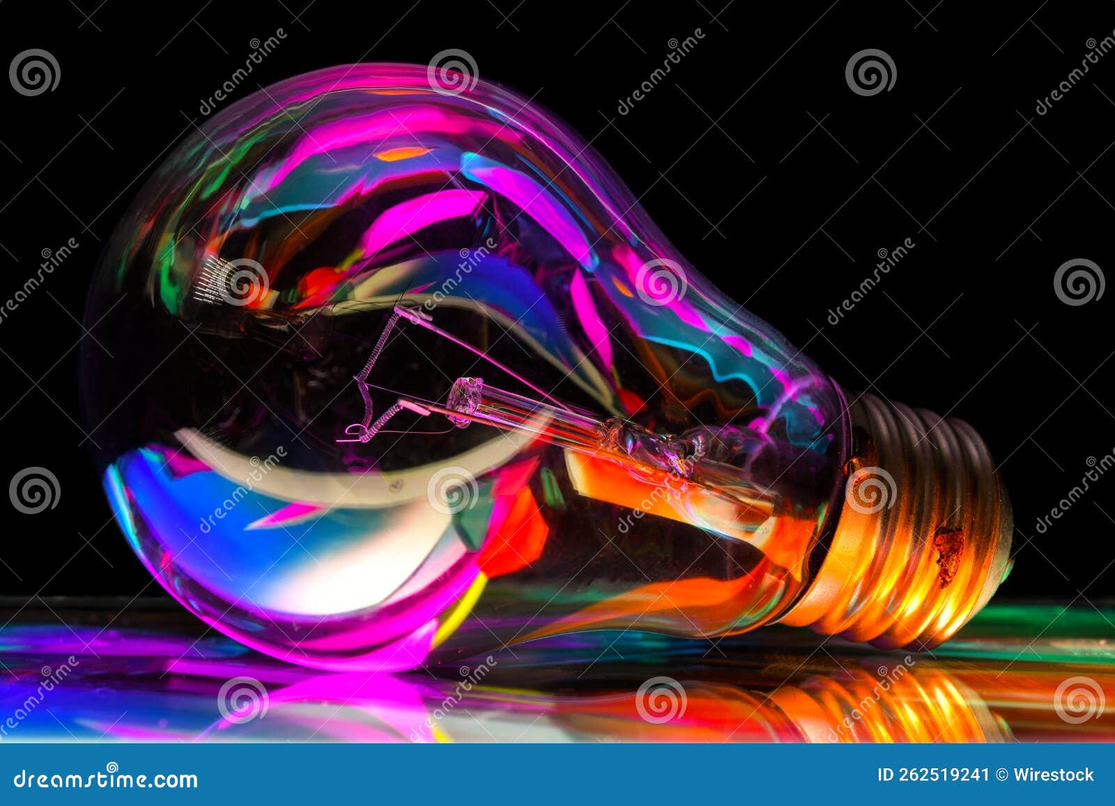 Light Bulb with Colorful Lights Reflecting in it Stock Image - Image of ...