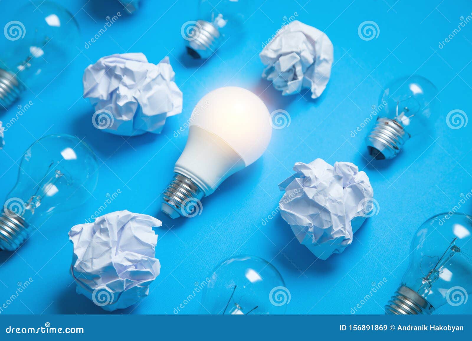 Light Bulb and Crumpled Papers in the Blue Background. Idea Stock Image ...