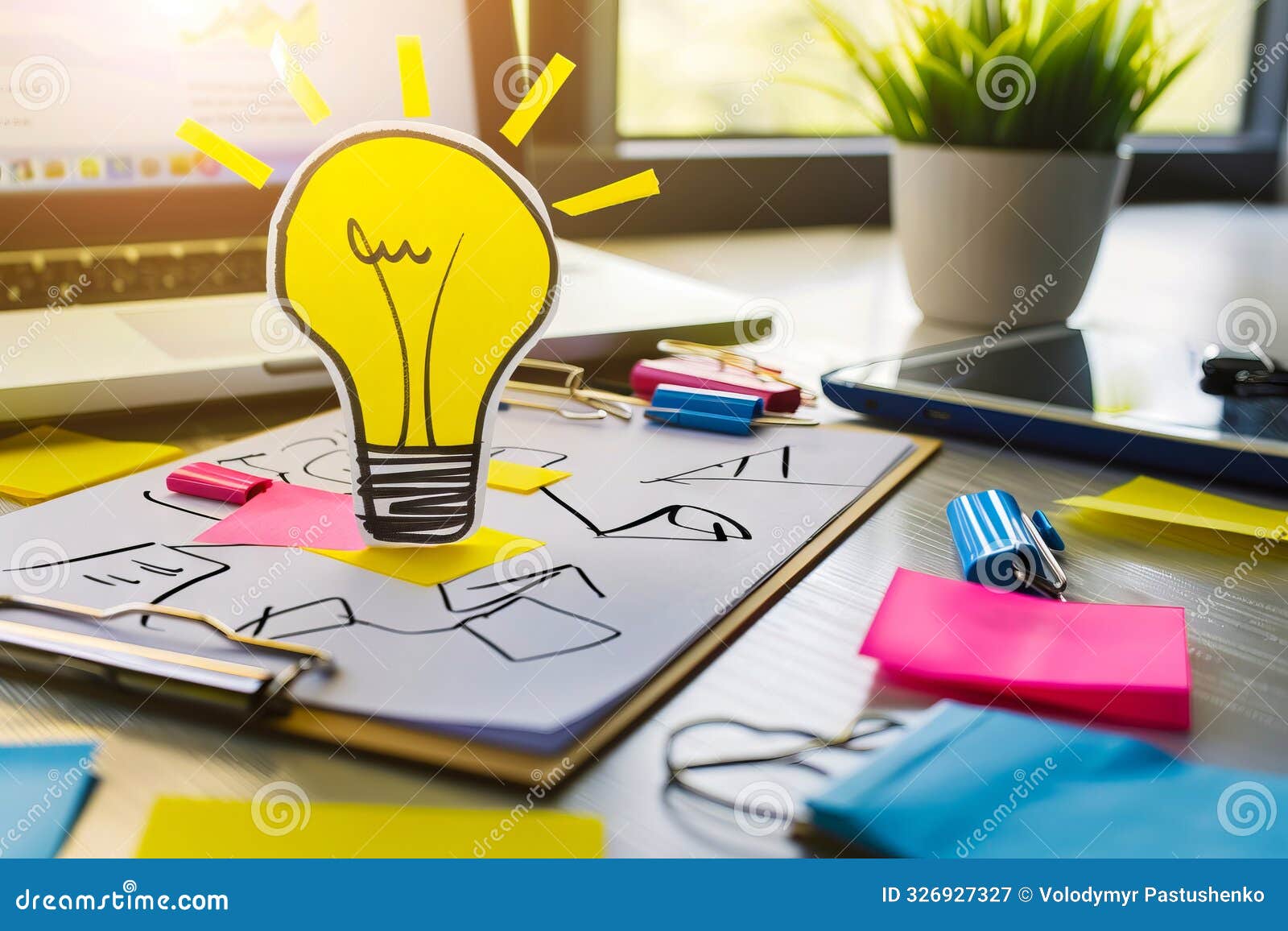 A Light Bulb on a Desk with Notes and Other Items Stock Image - Image ...
