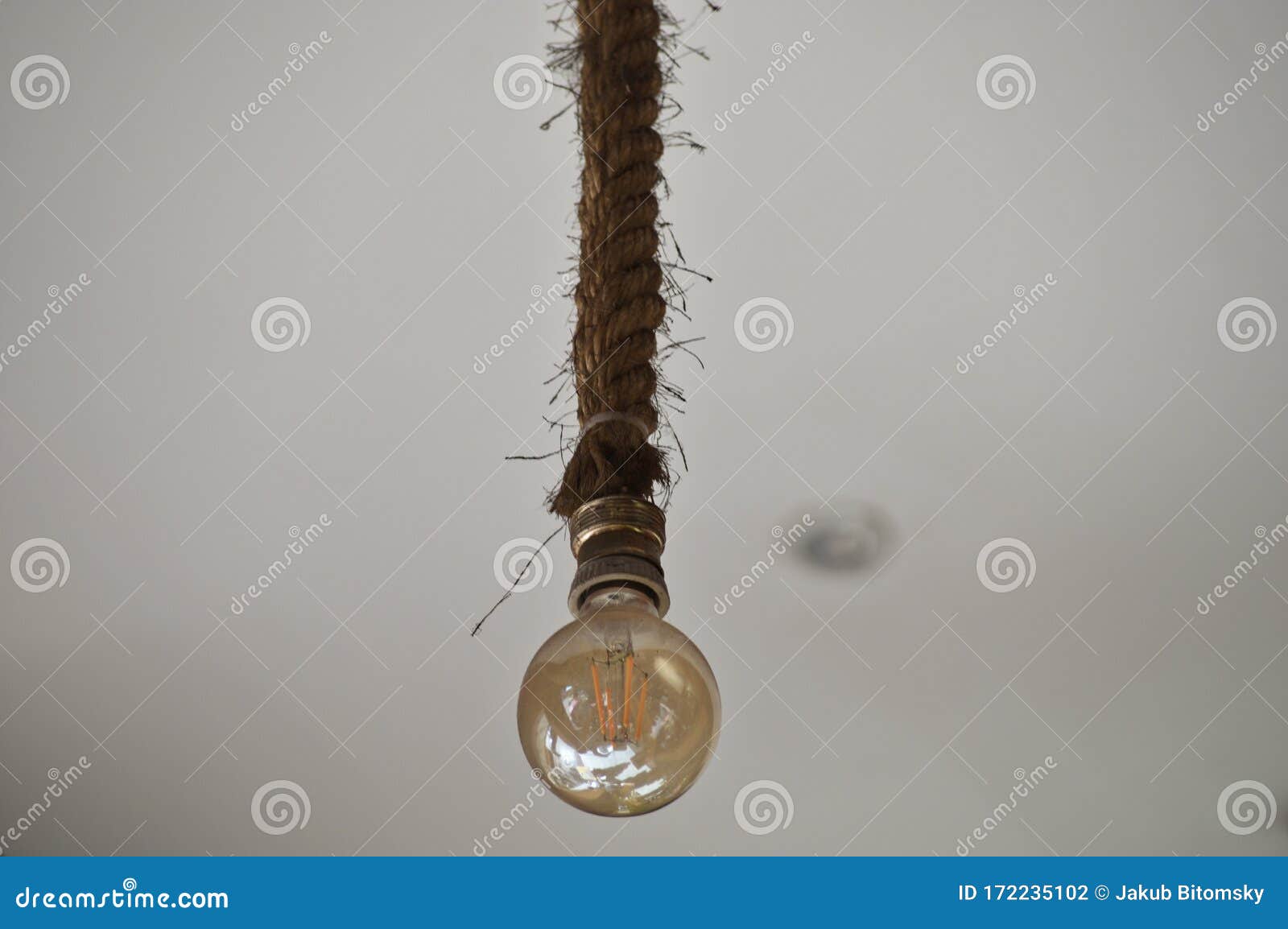 Light bulb on the rope stock photo. Image of exposed - 172235102