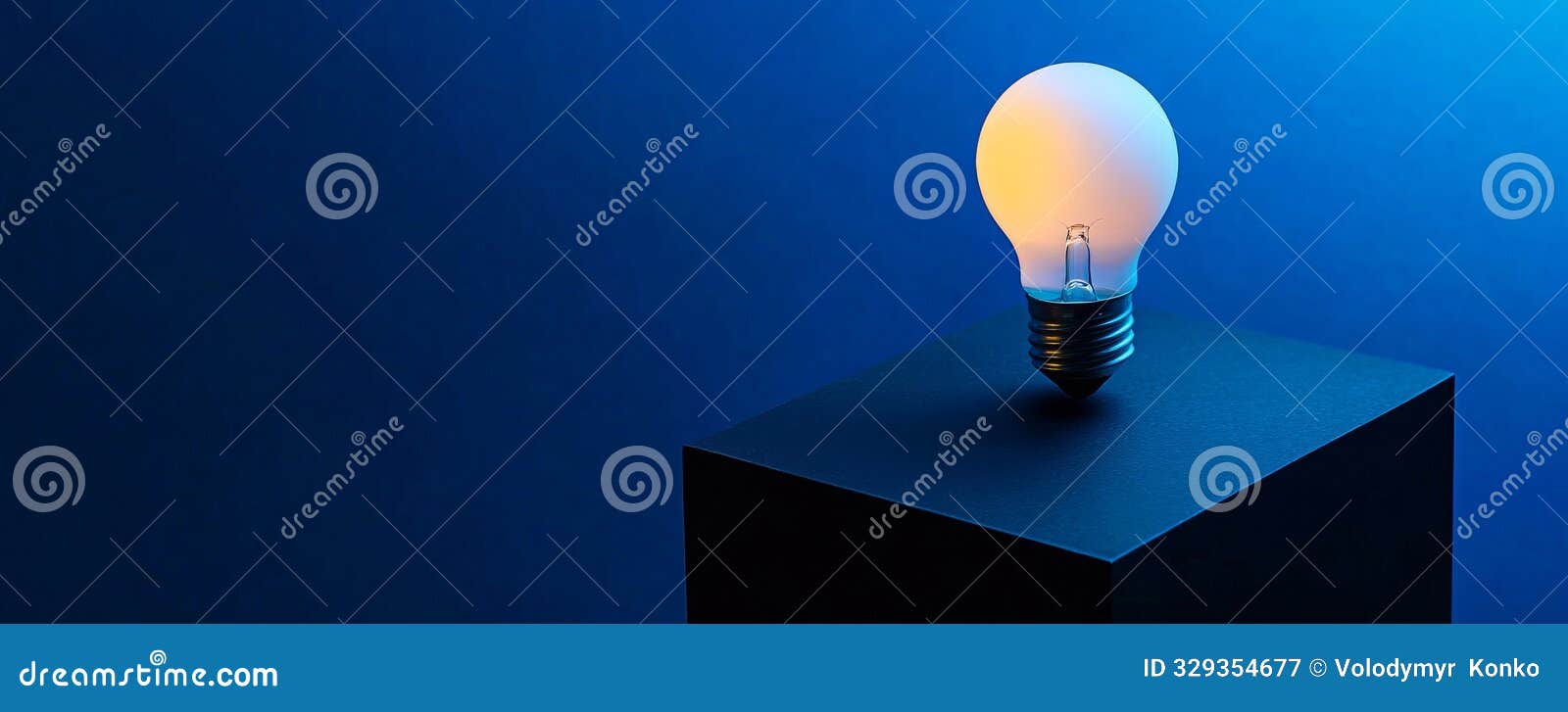 Light Bulb Glowing on a Black Cube Against Blue Gradient Background ...