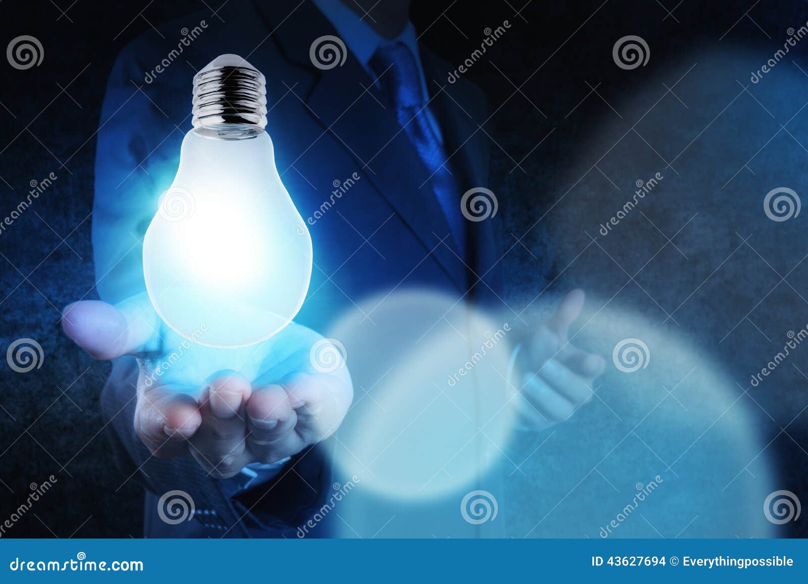 Light Bulb in Hand Businessman on Blue Tone Stock Photo - Image of ...