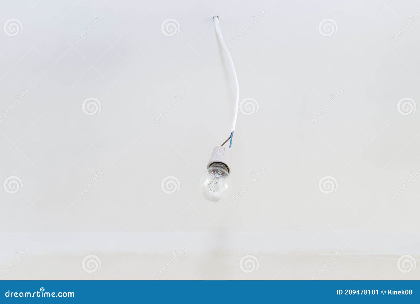 Light Bulb Hanging on a Cable Protruding from the Wall with a Ceramic ...