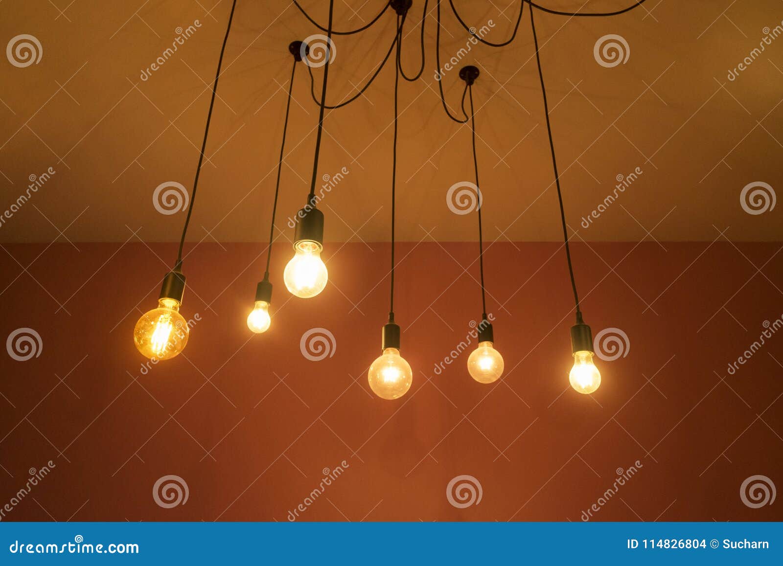 Light Bulb Hanging on Ceiling on Orange Background. Light Bulb H Stock ...