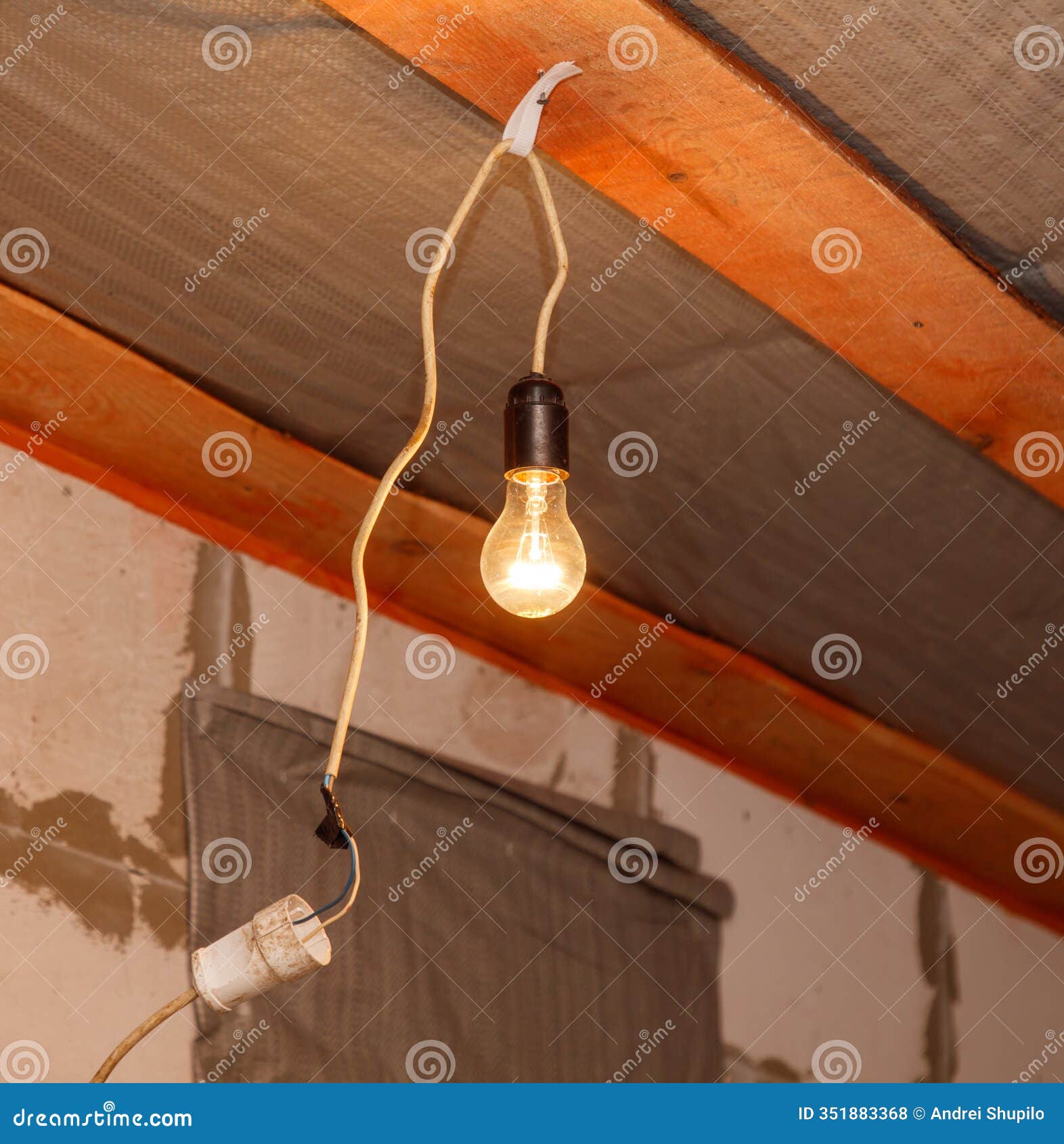 A Light Bulb Hanging from a Wire Stock Photo - Image of concept ...