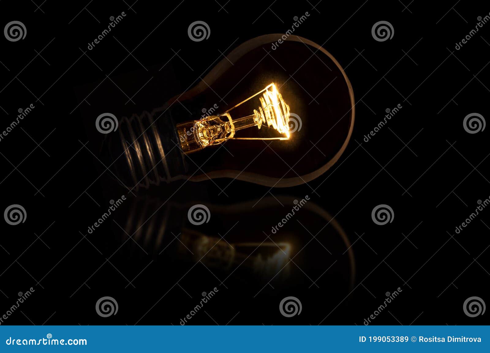 Light Bulb Incandescent Placed in the Dark with Reflection Stock Image ...
