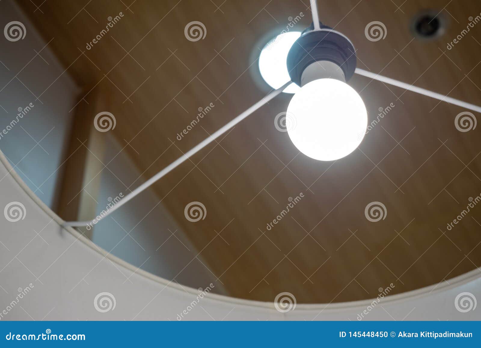 Light Bulb in Lamp Hanging from Ceiling on Blurred Background Stock ...