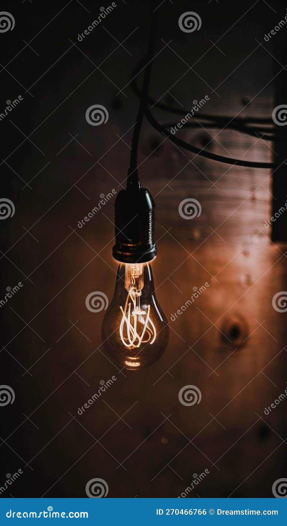 A Light Bulb is Lit Up on a Wooden Surface with a Wire Coming Out of ...