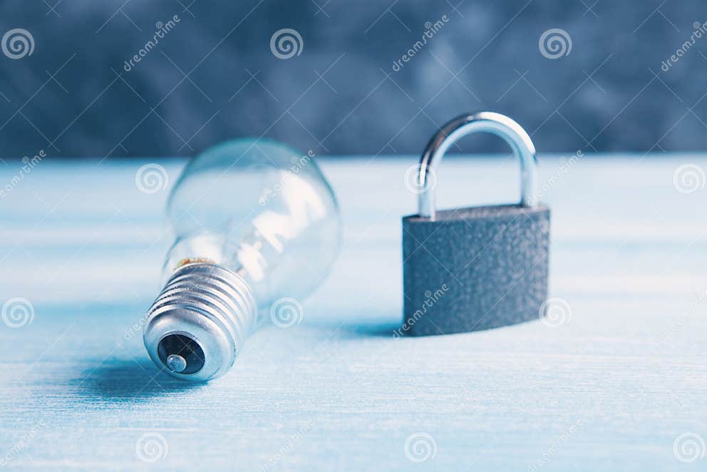 Light Bulb and Lock on the Table Stock Photo - Image of lock ...