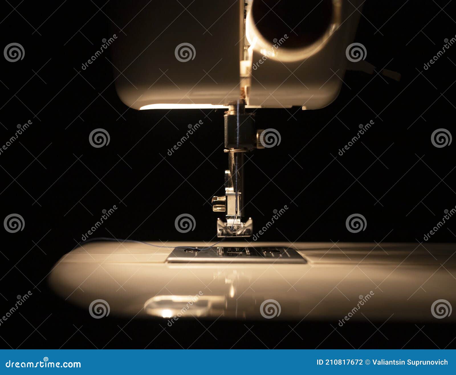 Light from Bulb of Modern Sewing Machine in Darkness Stock Photo ...