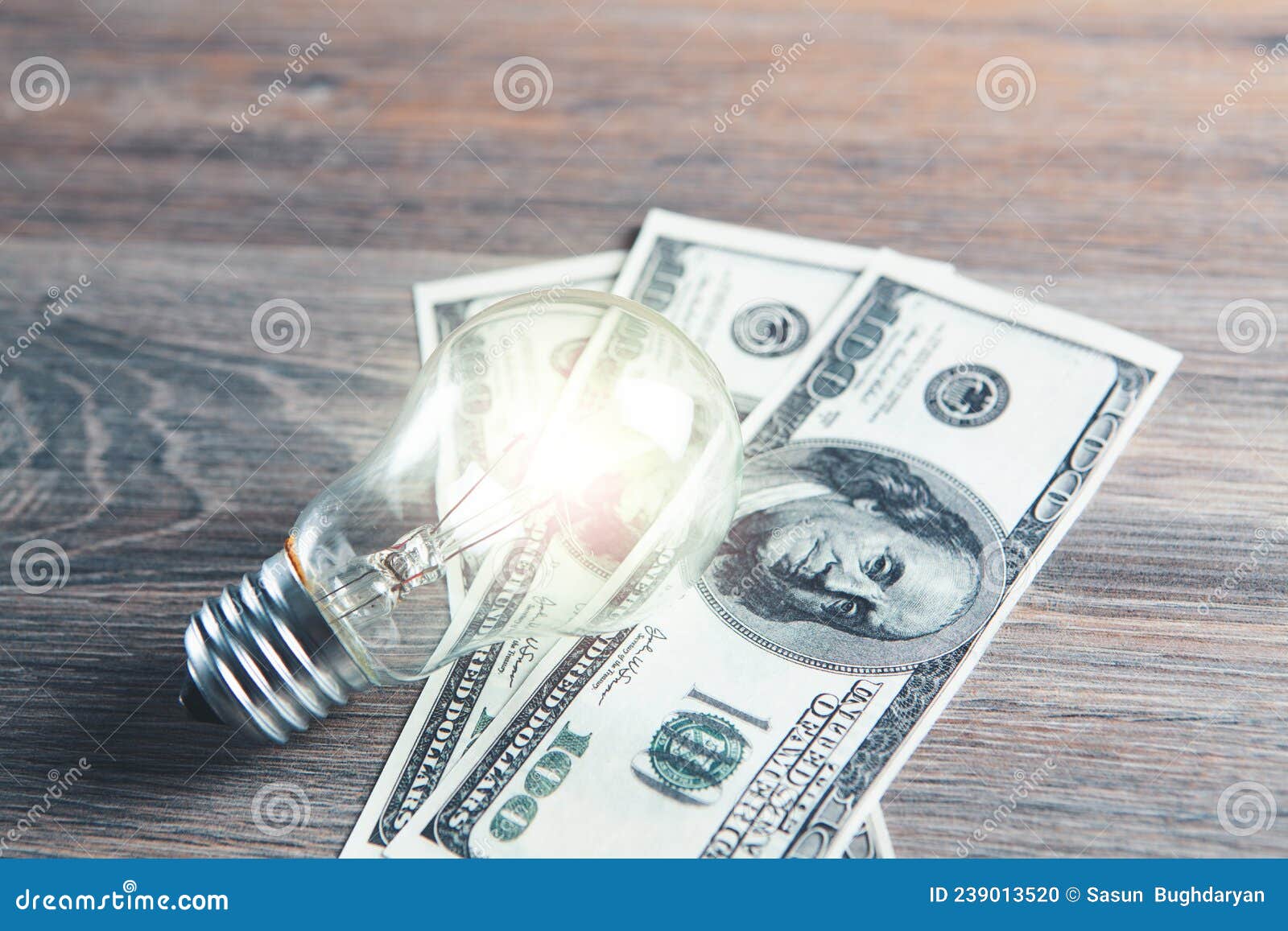 Light Bulb and Money on the Table Stock Photo - Image of investment ...