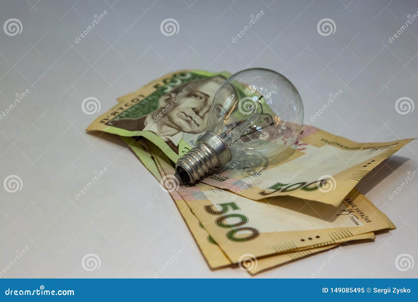 Light Bulb and Money on White Background. Energy Saving Stock Image ...