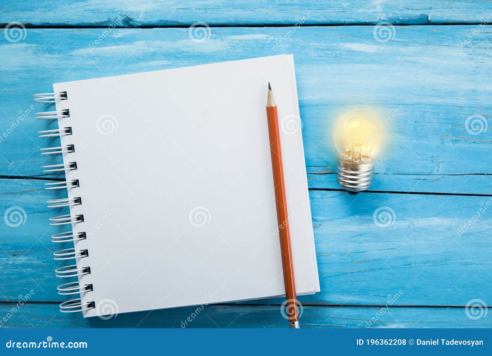 Light bulb with notepad stock photo. Image of education - 196362208