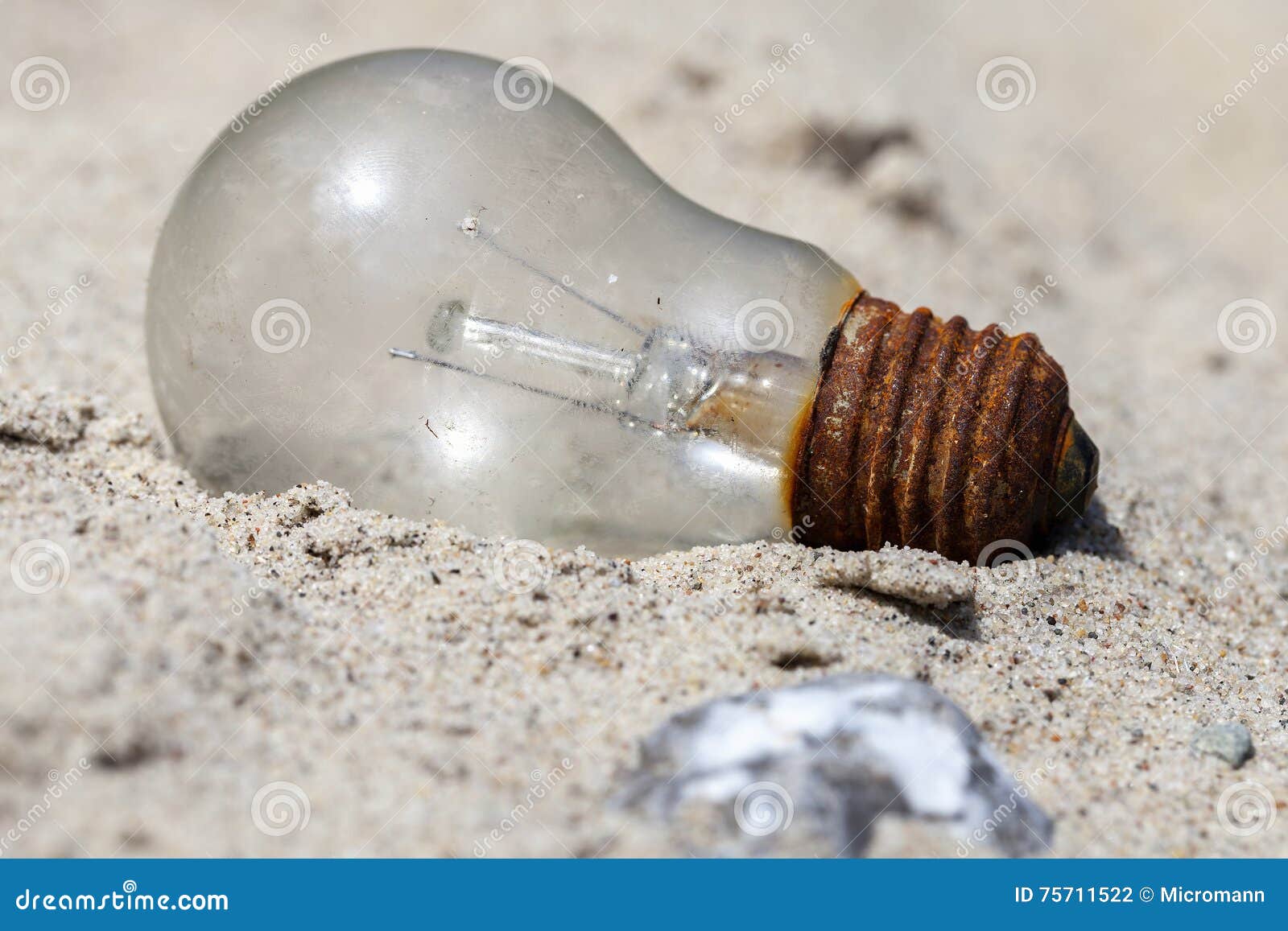 Light bulb in the sand stock photo. Image of fashioned - 75711522