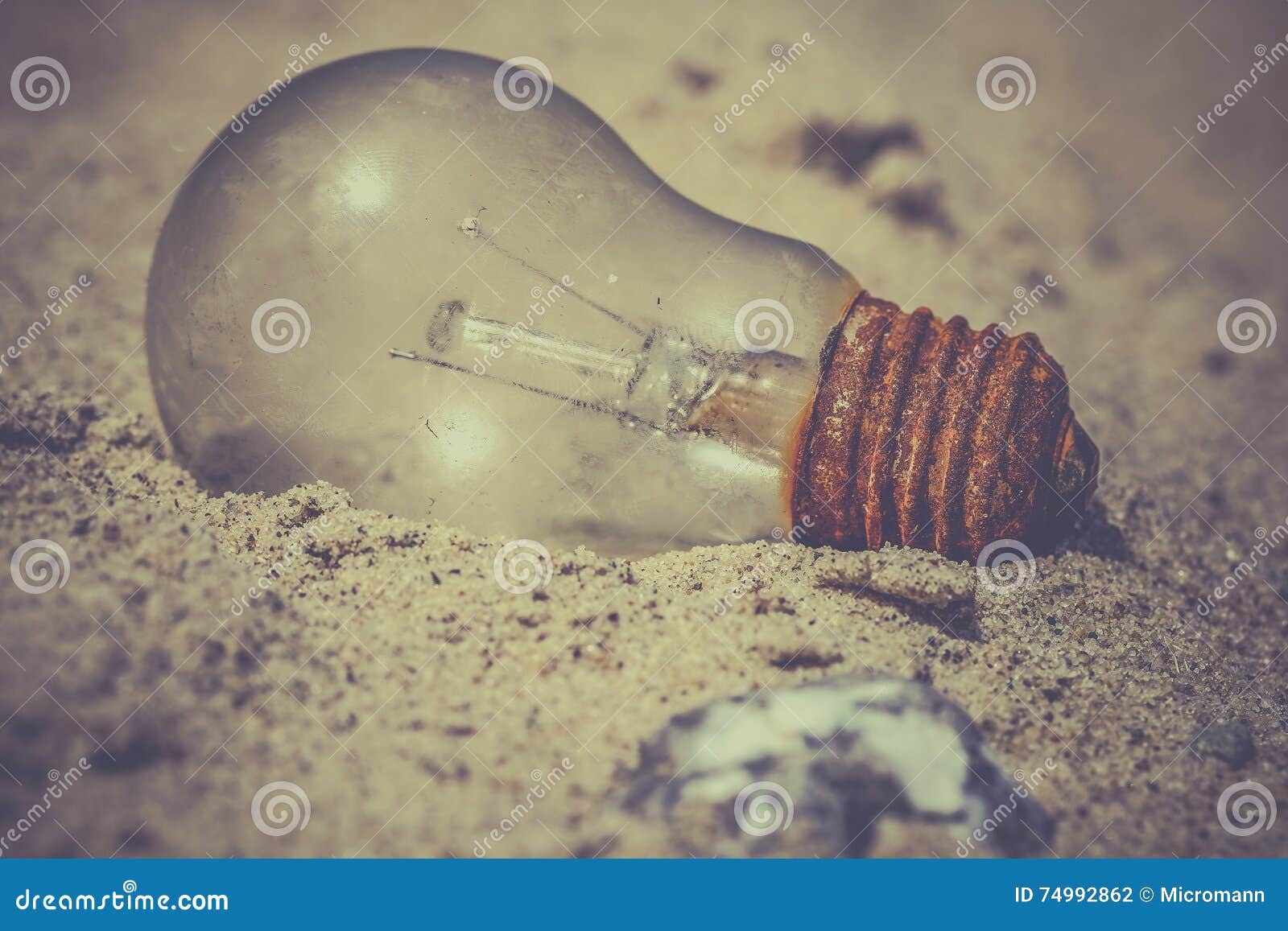 Light bulb in the sand stock photo. Image of glass, luminous - 74992862