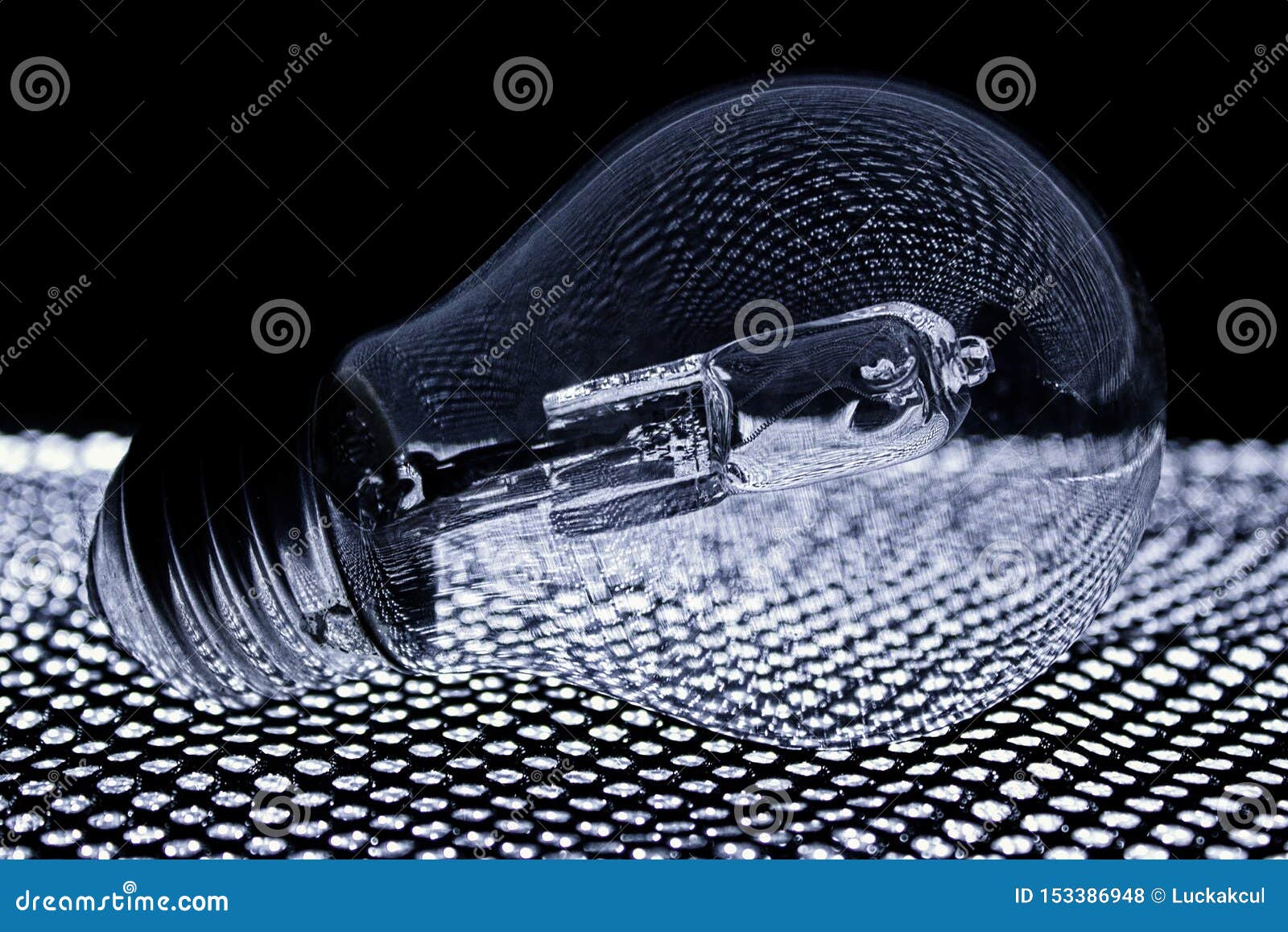 Light Bulb on Shining Background Mesh in Front of Black Background ...