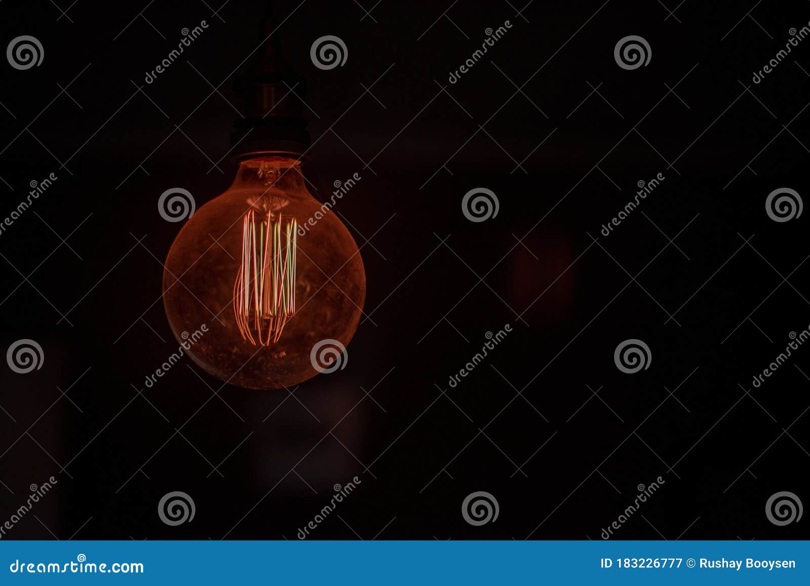 Light Bulb Shining in Dark Room with Copy Space Stock Image - Image of ...