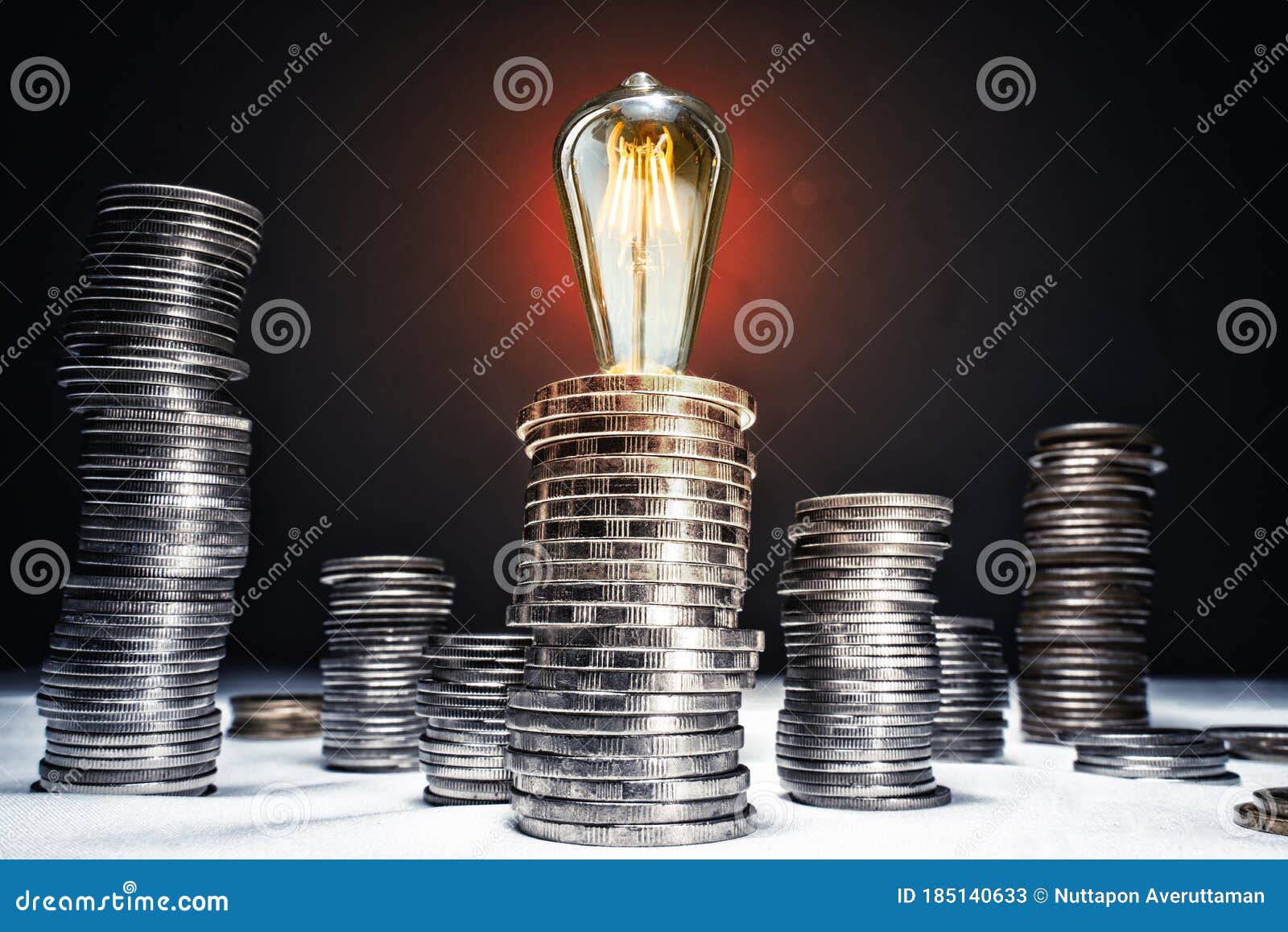 Light Bulb with Stacks of Coins for Financial Stock Image - Image of ...