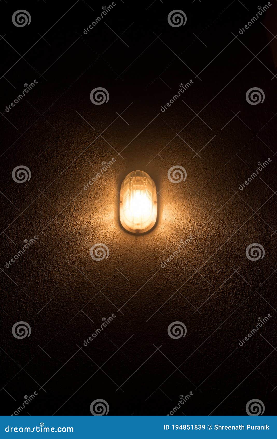 Light bulb on the wall stock image. Image of bright - 194851839