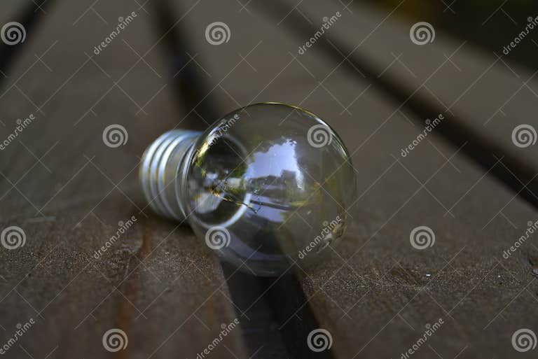 Light Bulb on a Wooden Surface Stock Photo - Image of electricity ...