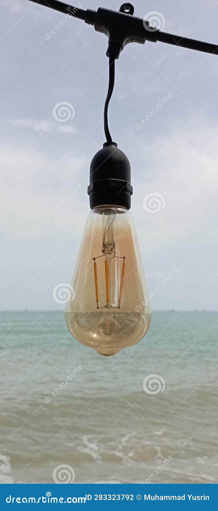 Light bulbs on the beach stock photo. Image of night - 283323792