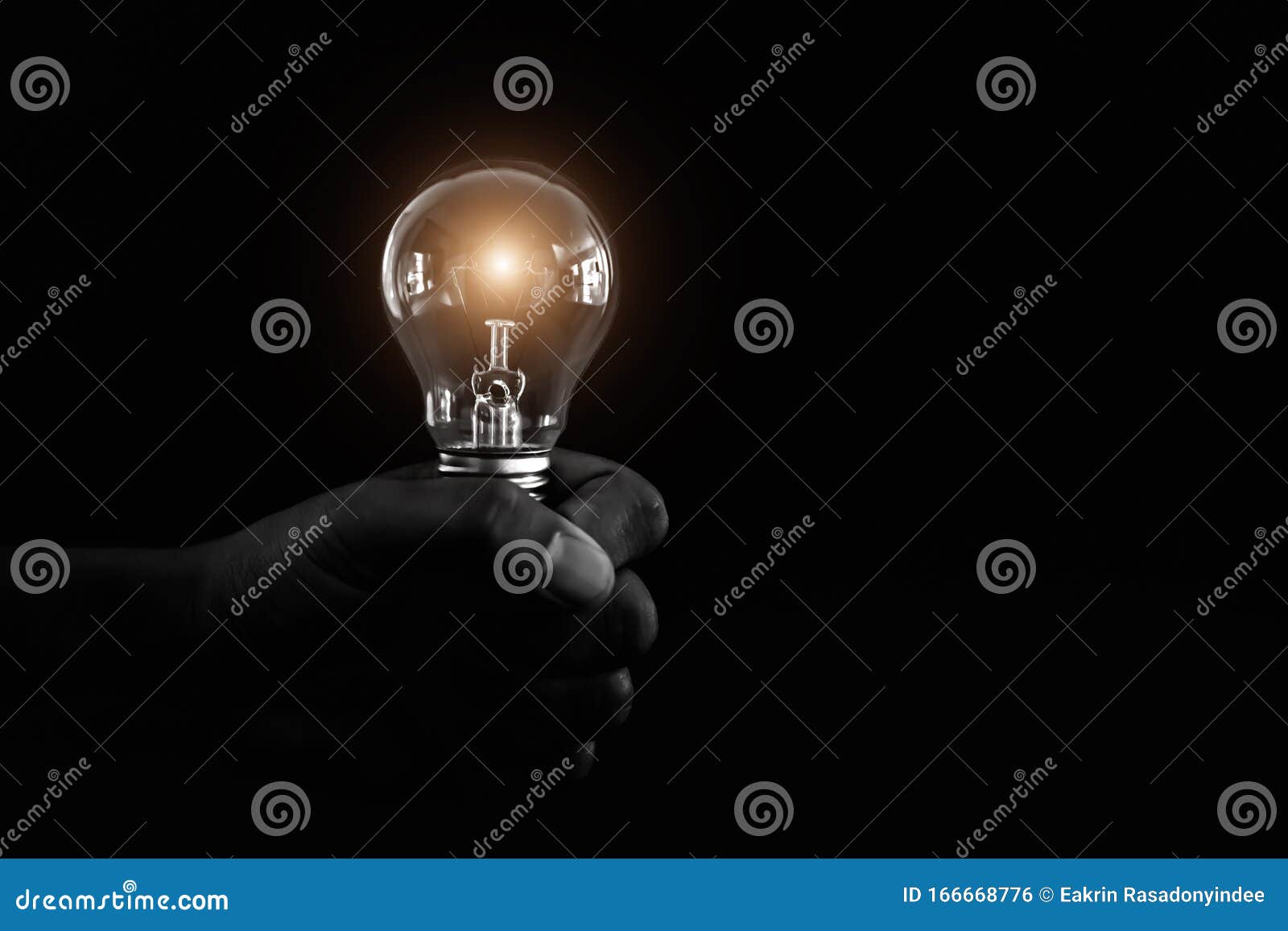 Light Bulbs with Bright Light in Hand with Dark Background. Stock Photo ...