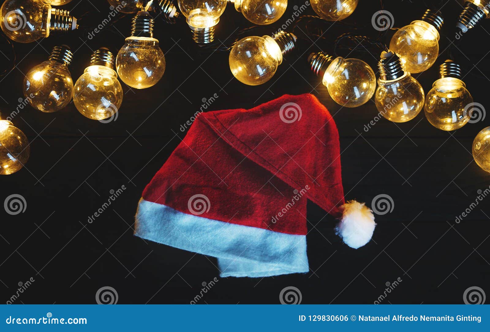 Light Bulbs and Santa Hat on Black Wood. Top View Stock Photo - Image ...
